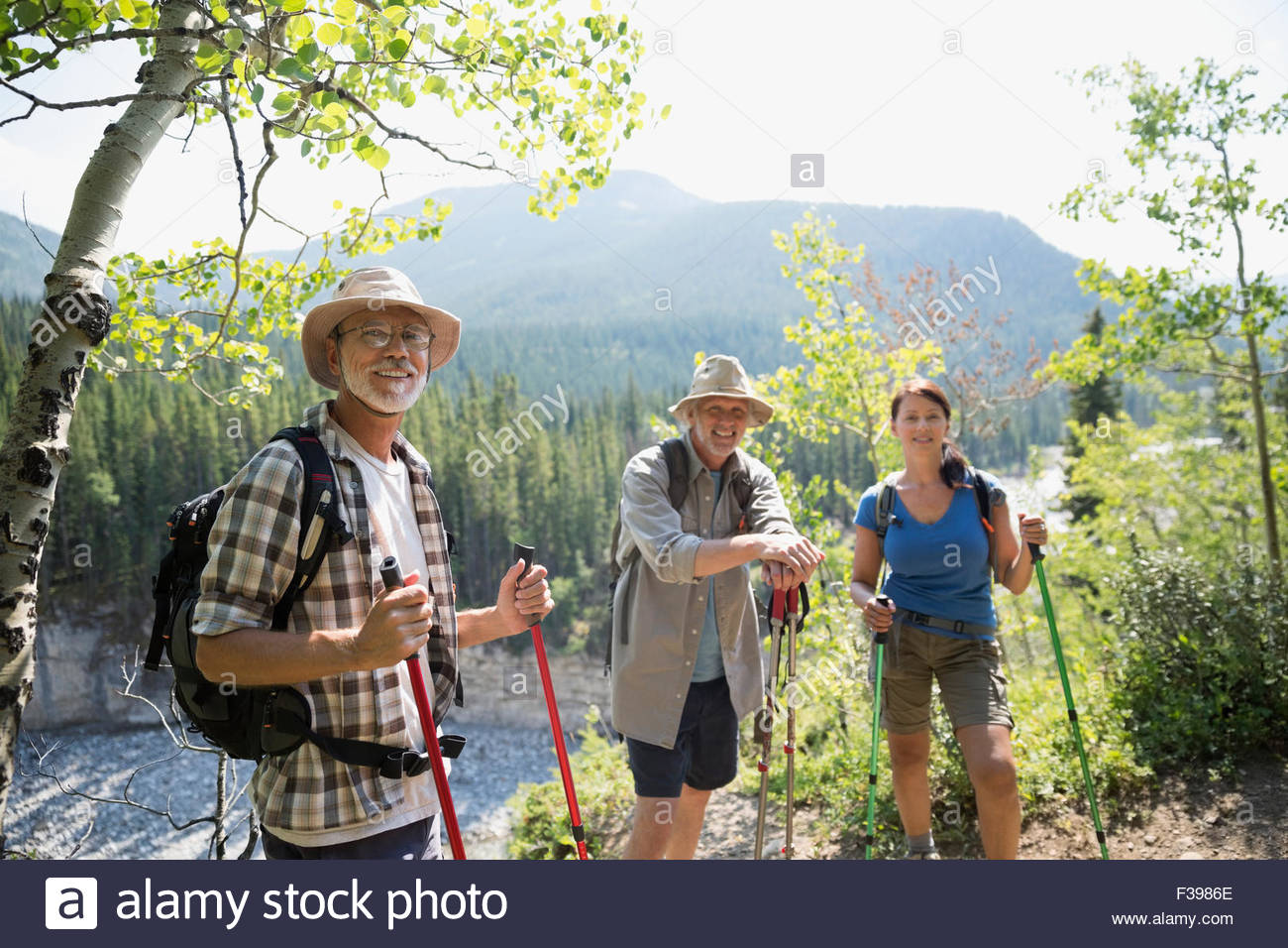 Portrait confident hikers with poles on trail Stock Photo - Alamy