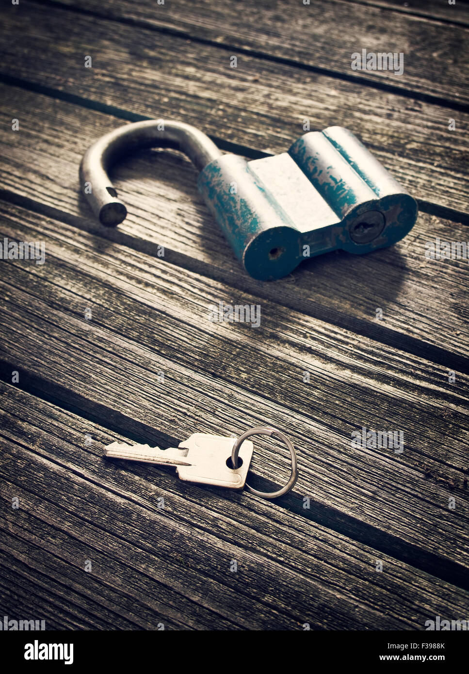 Key and lock on wooden background Stock Photo - Alamy