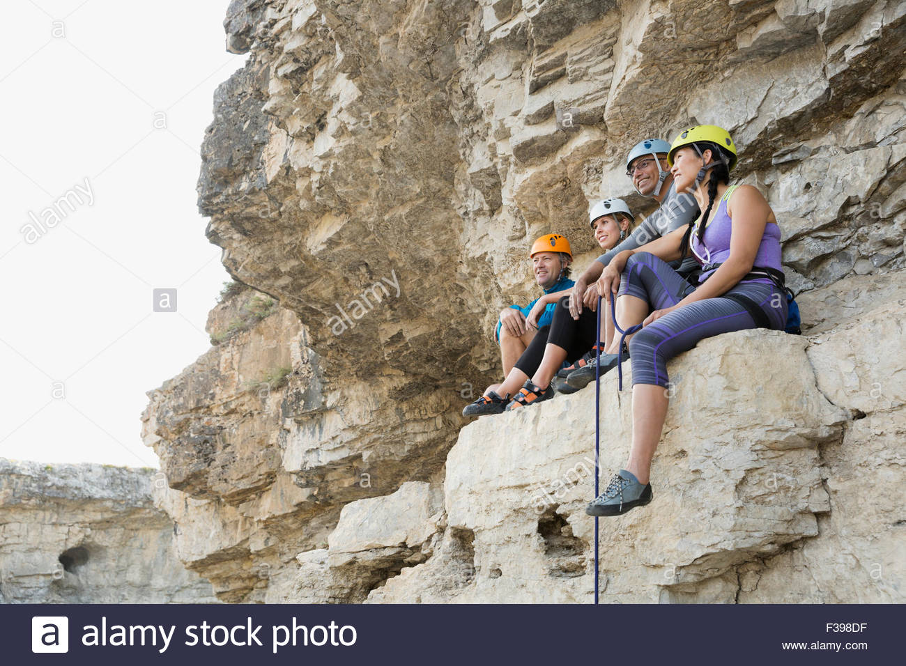 Women sitting on rock hi-res stock photography and images - Alamy