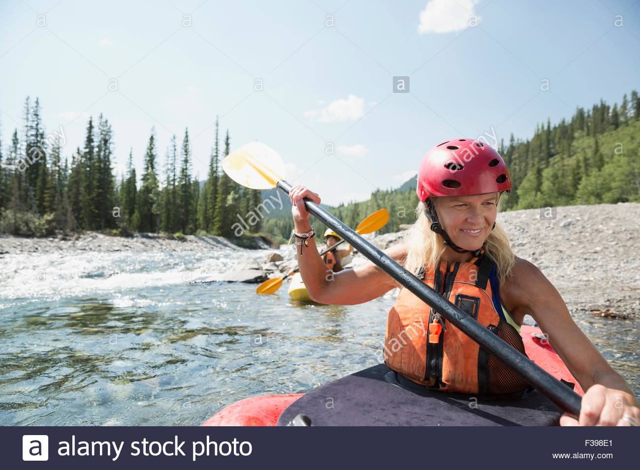 Smiling woman kayaking in river Stock Photo - Alamy