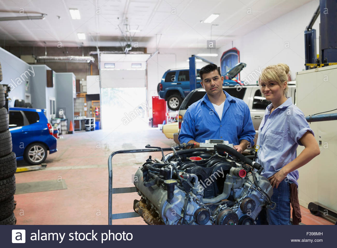 Portrait confident mechanics at engine auto repair shop Stock Photo - Alamy