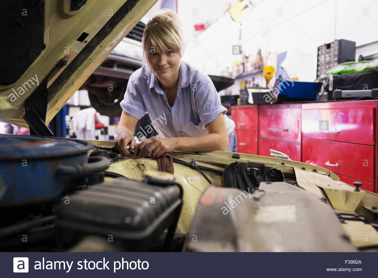 Auto mechanic working under hood hi-res stock photography and images - Alamy