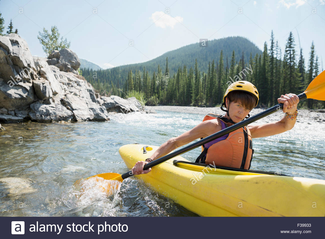 Determined woman kayaking in river Stock Photo - Alamy