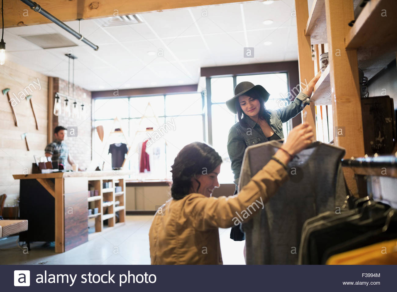 Women browsing at clothing in shop Stock Photo - Alamy