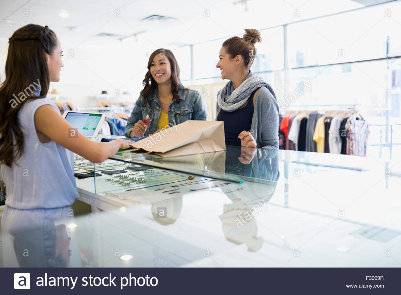 Women buying at shop counter Stock Photo - Alamy