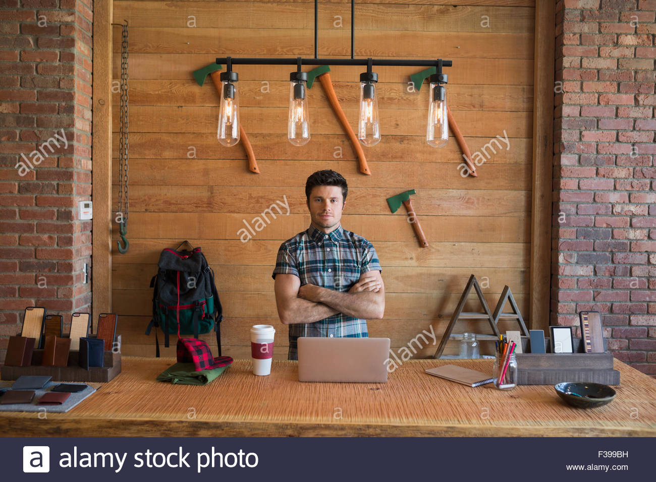 Portrait confident business owner behind shop counter Stock Photo - Alamy