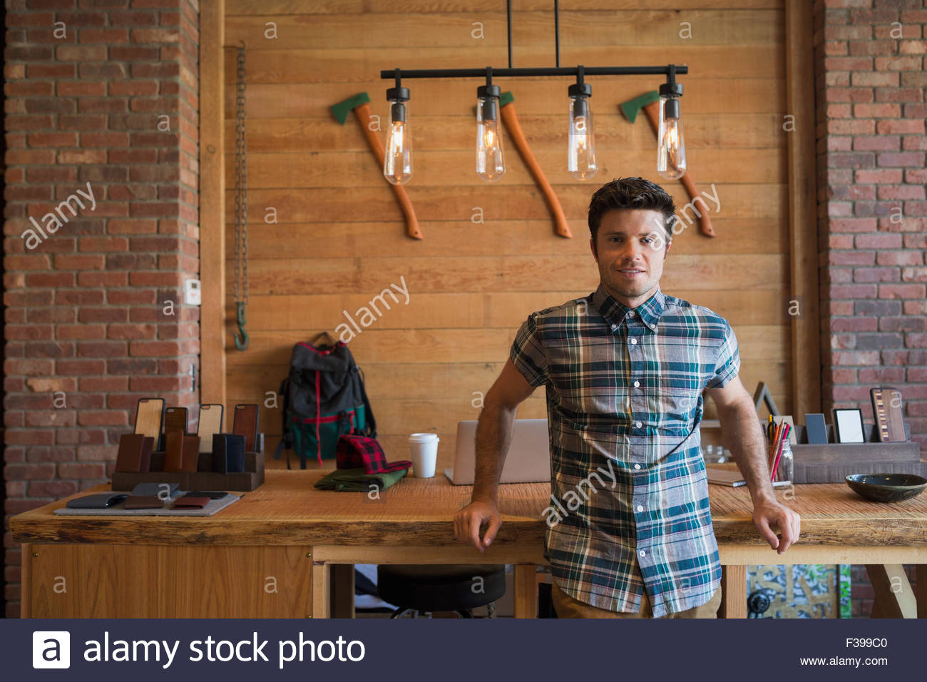 Portrait confident business owner leaning on shop counter Stock Photo ...