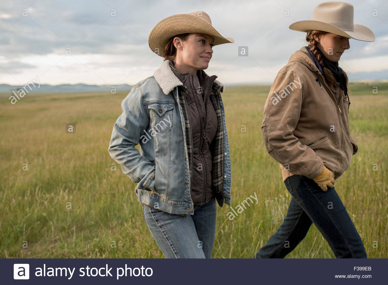 Female ranchers walking in remote rural field Stock Photo - Alamy