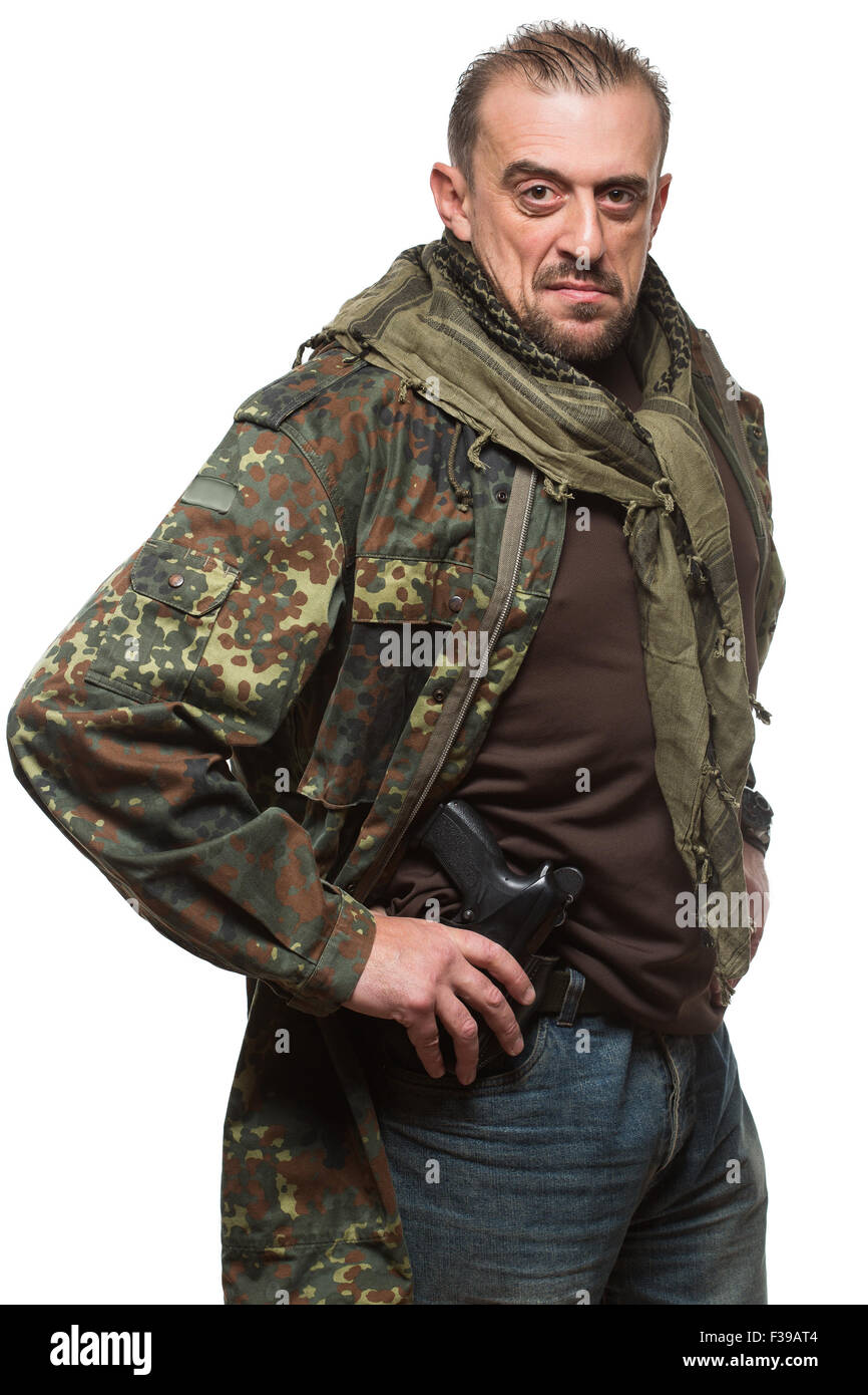 Male terrorist in a military jacket with a gun in his hand Stock Photo ...
