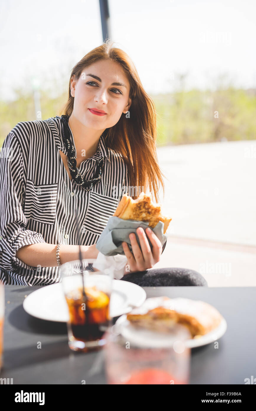 Young beautiful brunette eastern girl having an happy hour in a bar ...