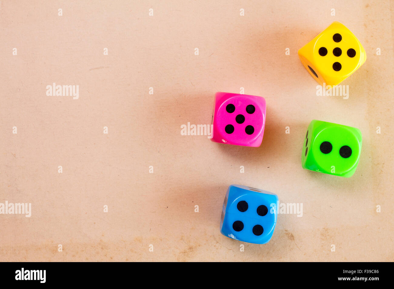 Four color dice on the cardboard background with copy-space Stock Photo ...