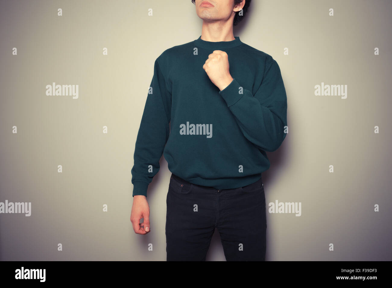 A young man is standing in a powerful pose Stock Photo - Alamy