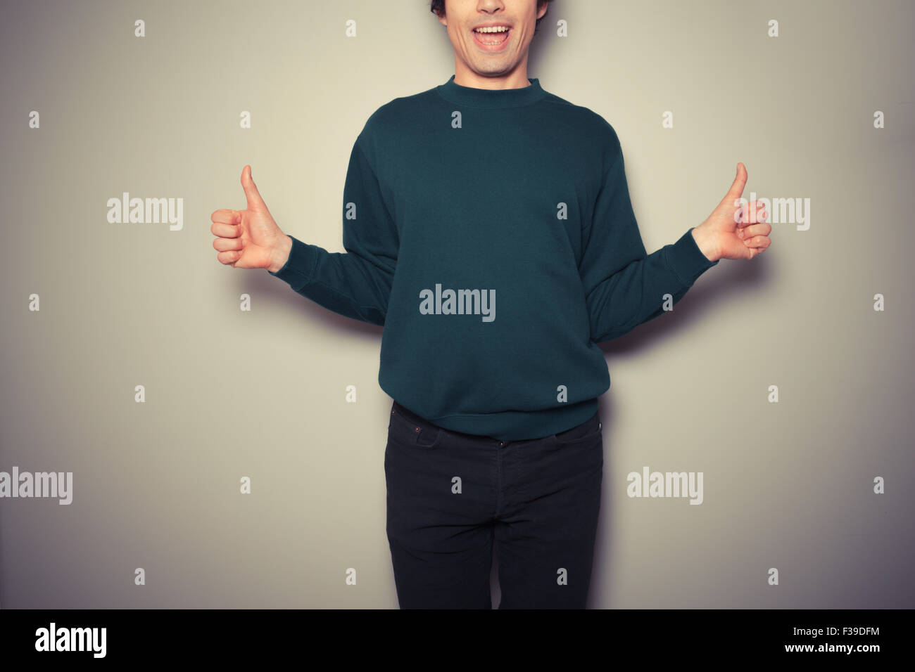 A young man is giving two thumbs up Stock Photo - Alamy