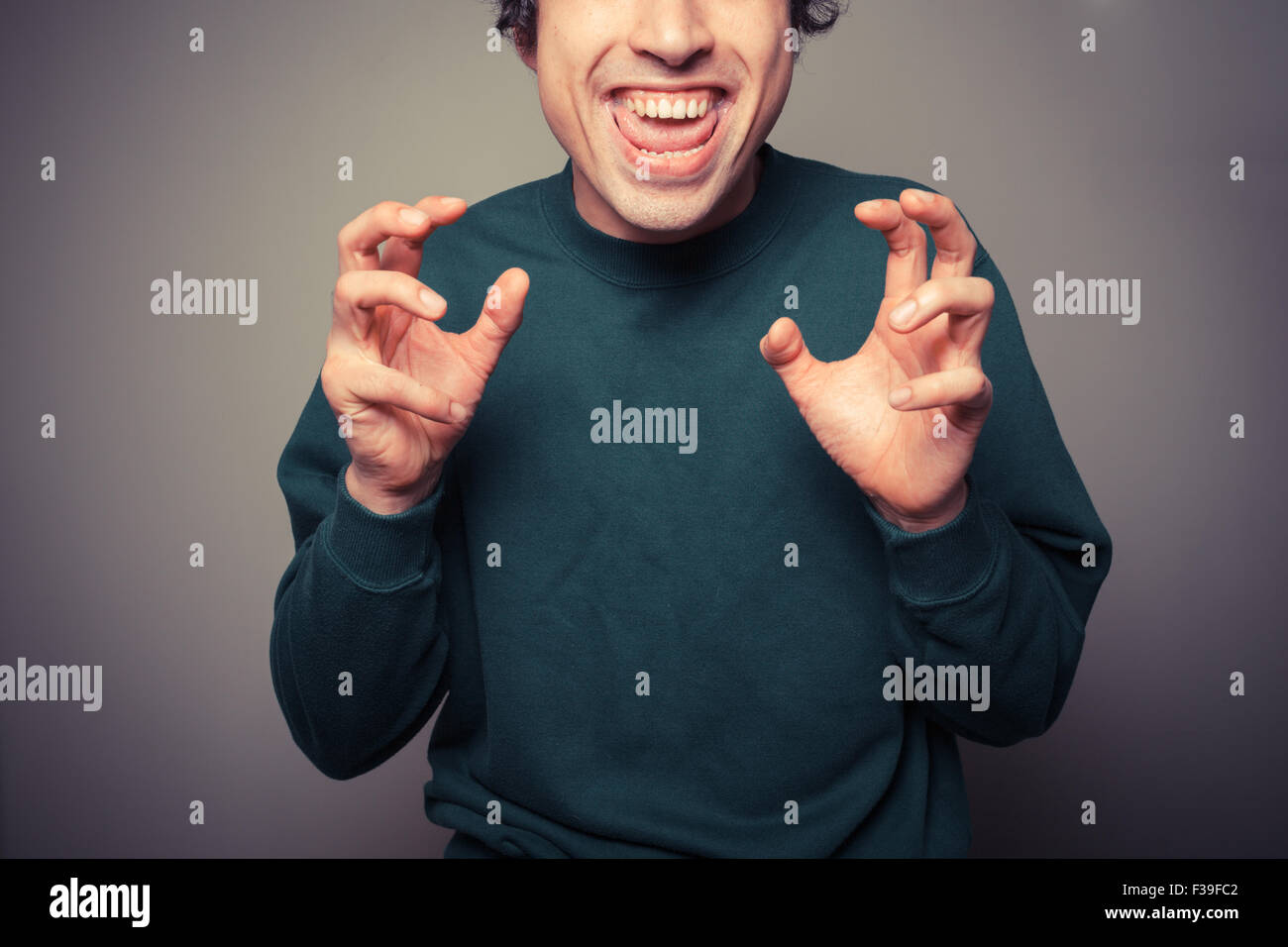 A young man is gesturing and pulling silly faces Stock Photo - Alamy