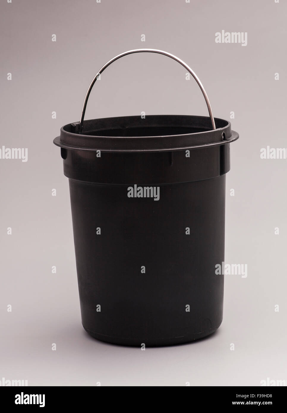 Black plastic bucket isolated on gray background Stock Photo - Alamy