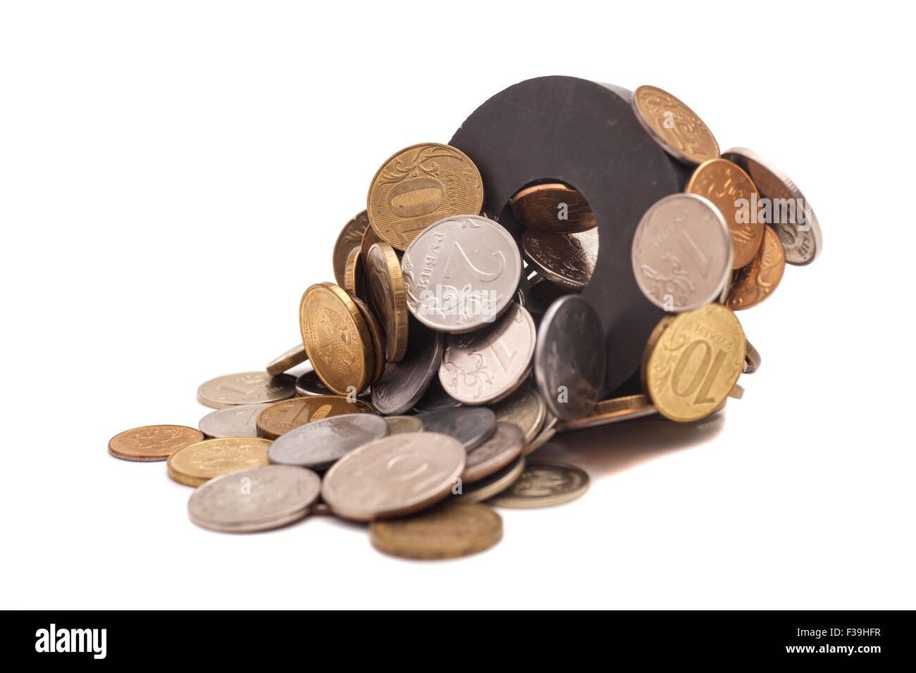Coins attracted by magnet Stock Photo - Alamy
