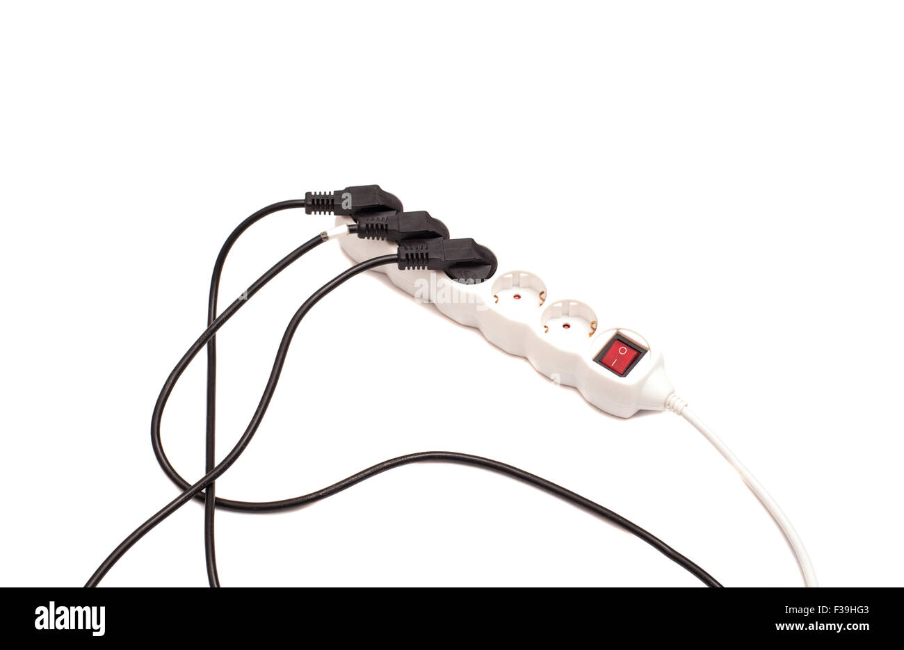 Many plugs plugged into electric power bar isolated on white Stock ...