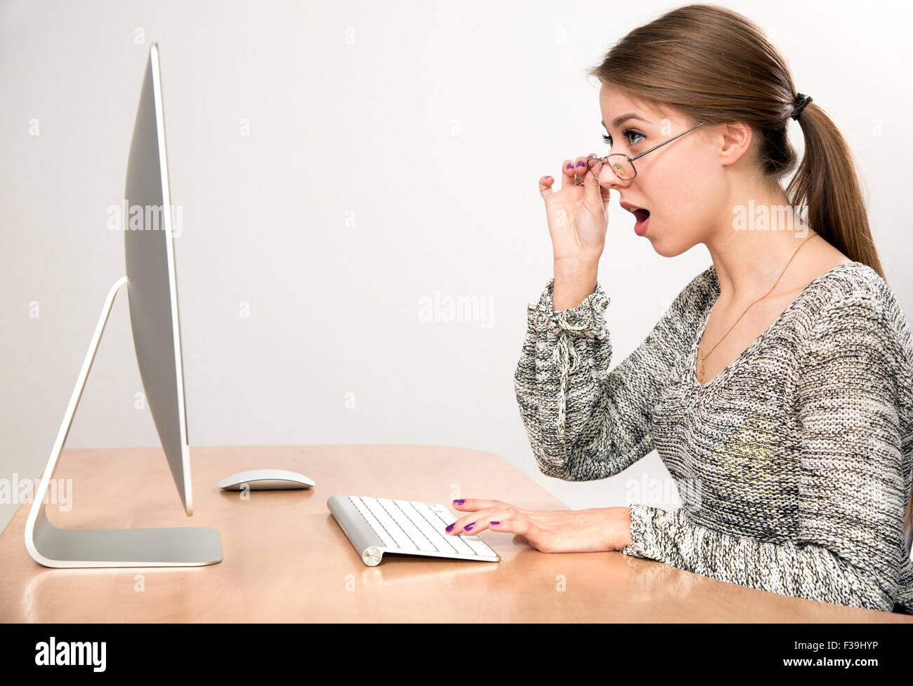 Surprising news Young beautiful lady expresses shock Stock Photo - Alamy
