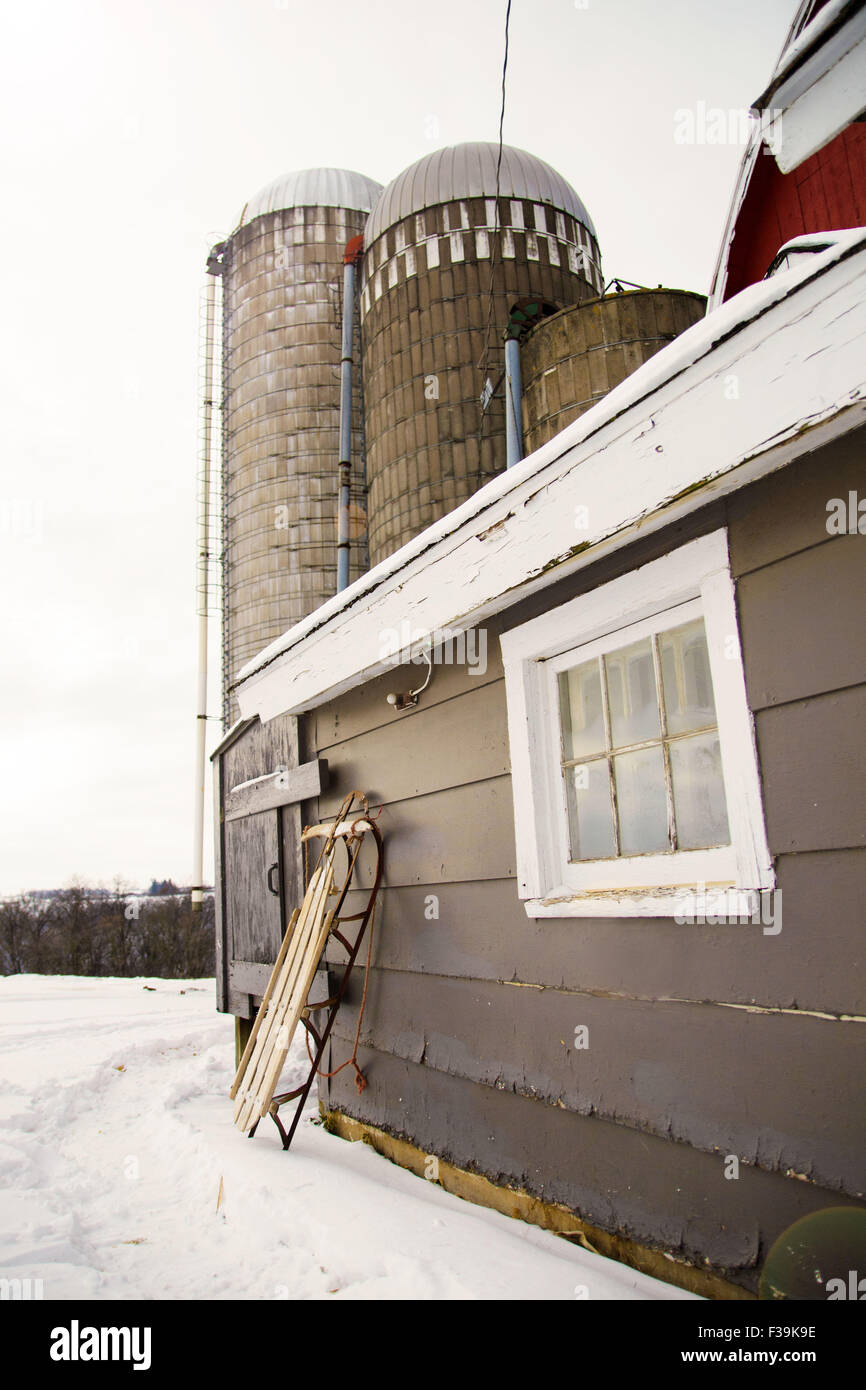 Sledge leaning against a farm building Stock Photo - Alamy
