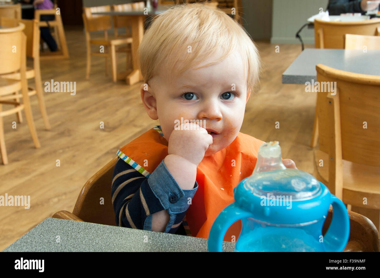 Baby boy eating lunch in a cafe Stock Photo - Alamy
