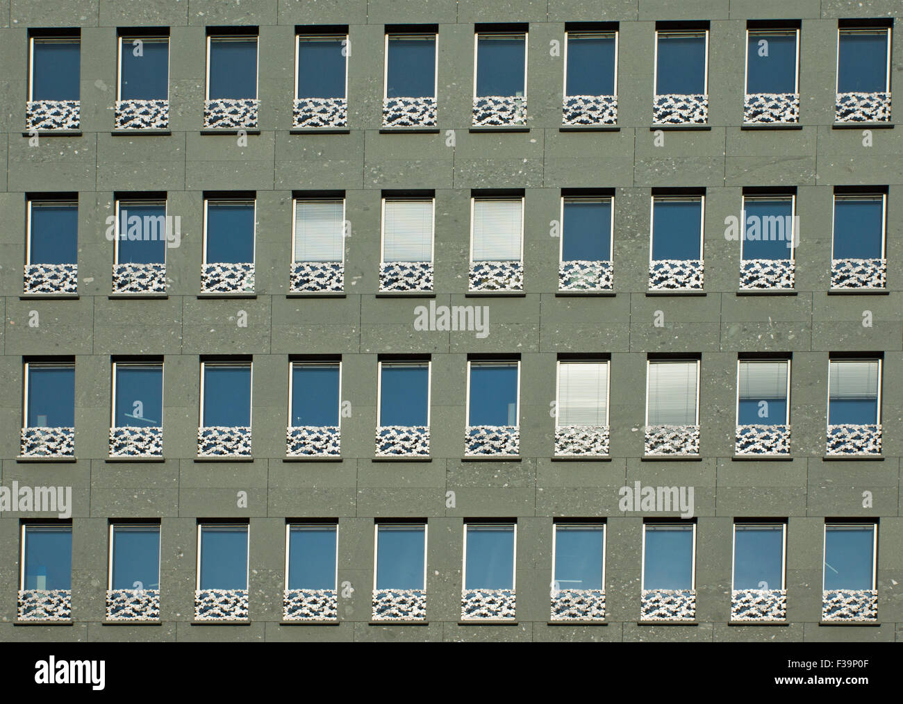 Green facade with some closed silver window shutters Stock Photo - Alamy