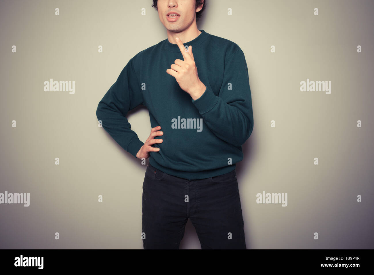 A Young man thinks he is cool and is making urban gestures with his ...