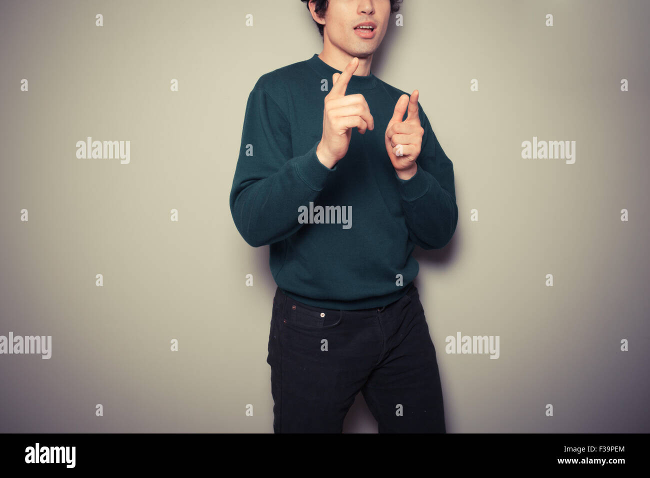 A Young man thinks he is cool and is making urban gestures with his ...