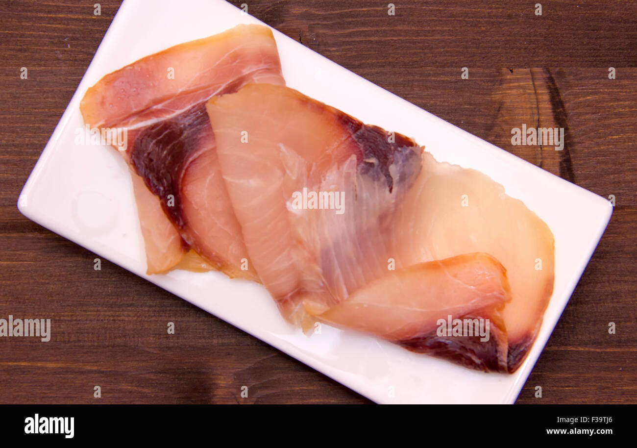 Smoked swordfish on small tray on wooden table seen from above Stock ...