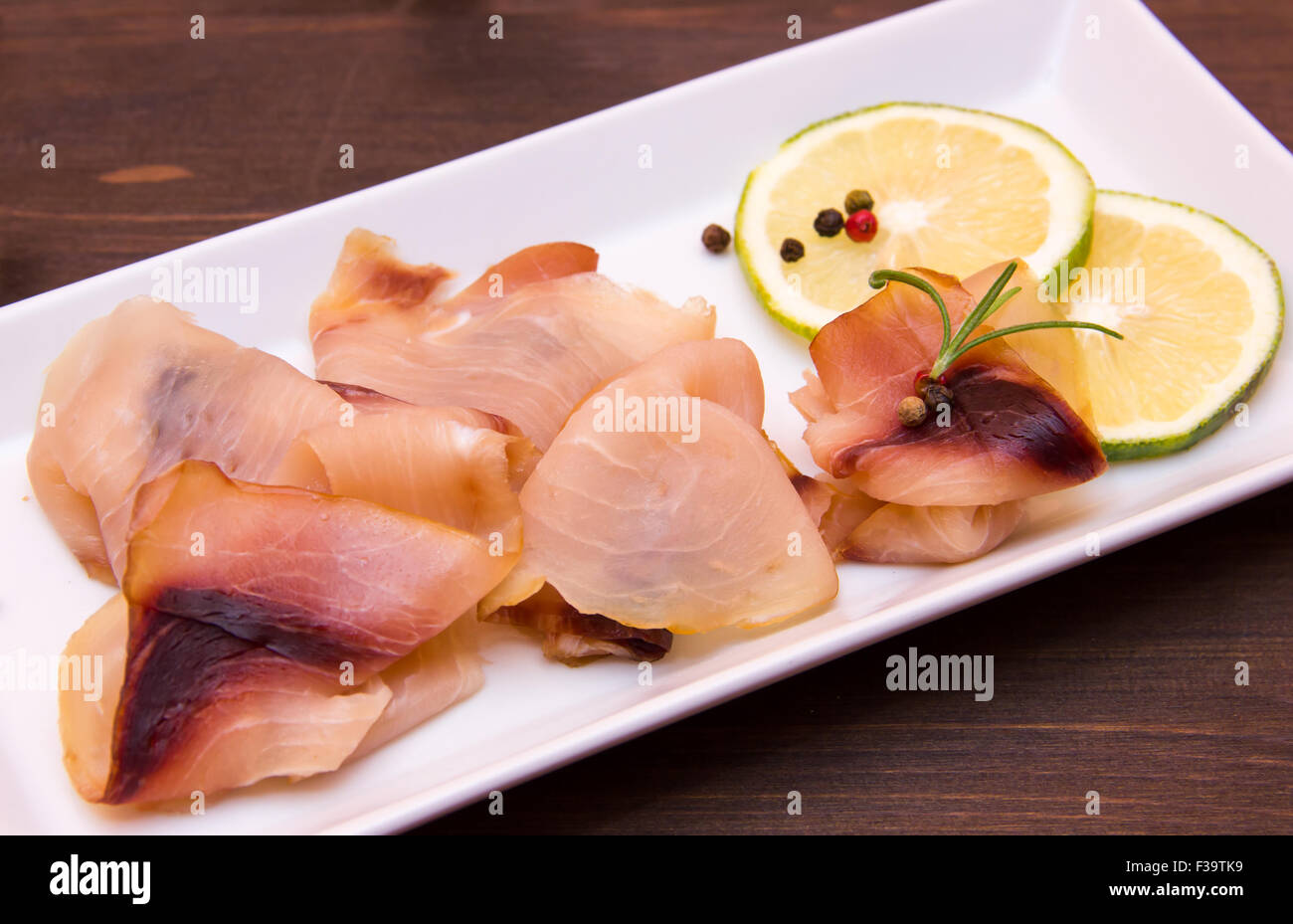 Smoked swordfish on tray on wood close Stock Photo - Alamy