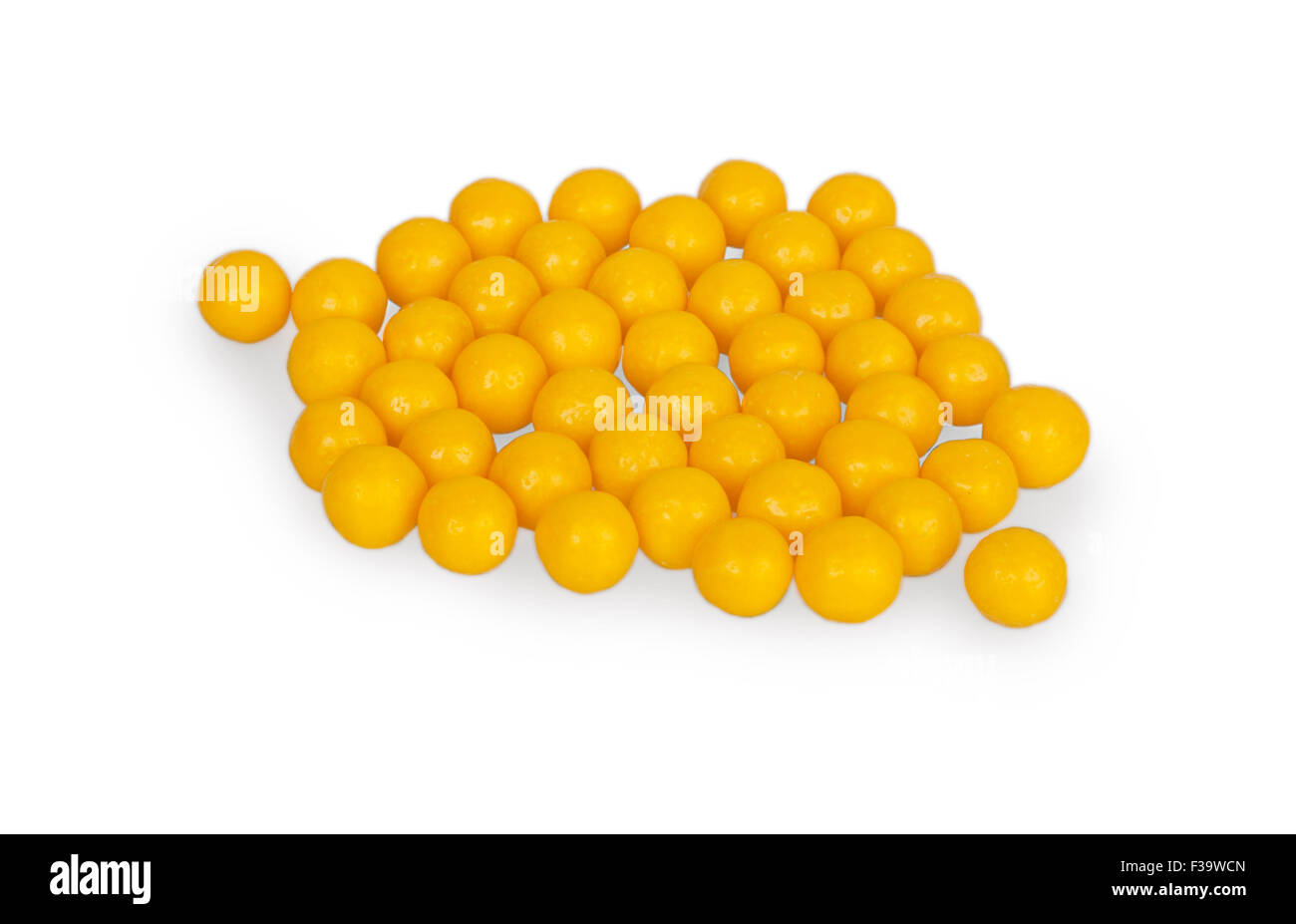 large round yellow pills isolated on white background Stock Photo - Alamy