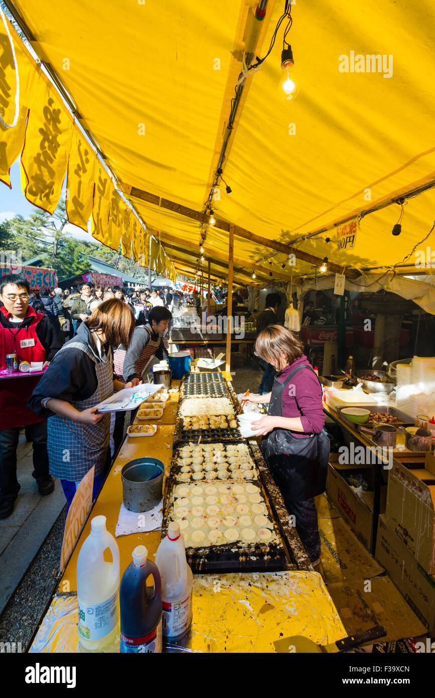 Nishinomiya Shinto shrine, at Shogatsu, New Year. Woman cooking ...