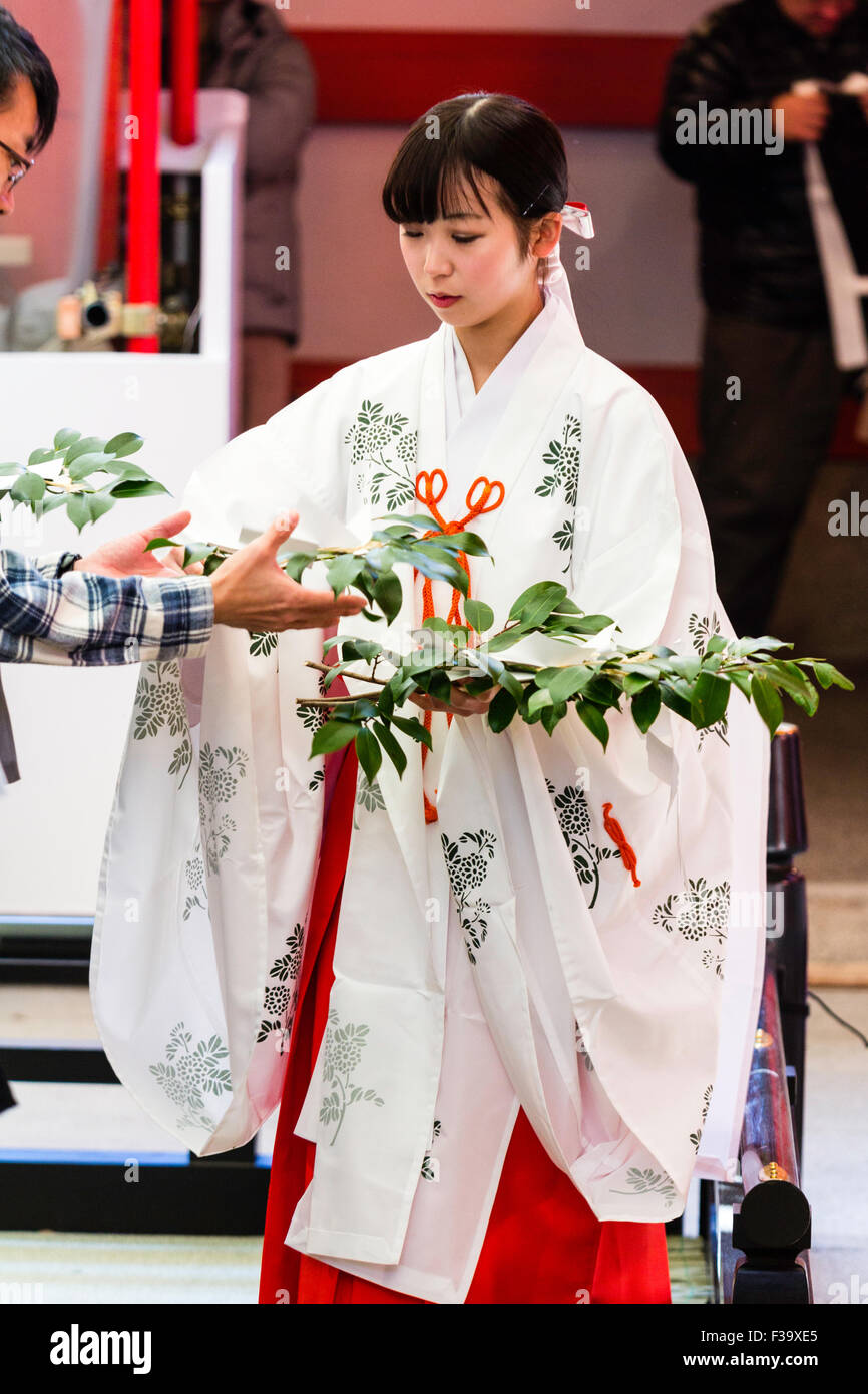 Japan, Kobe, Ikuta Shinto Shrine, Miko, shrine maiden, handing out ...