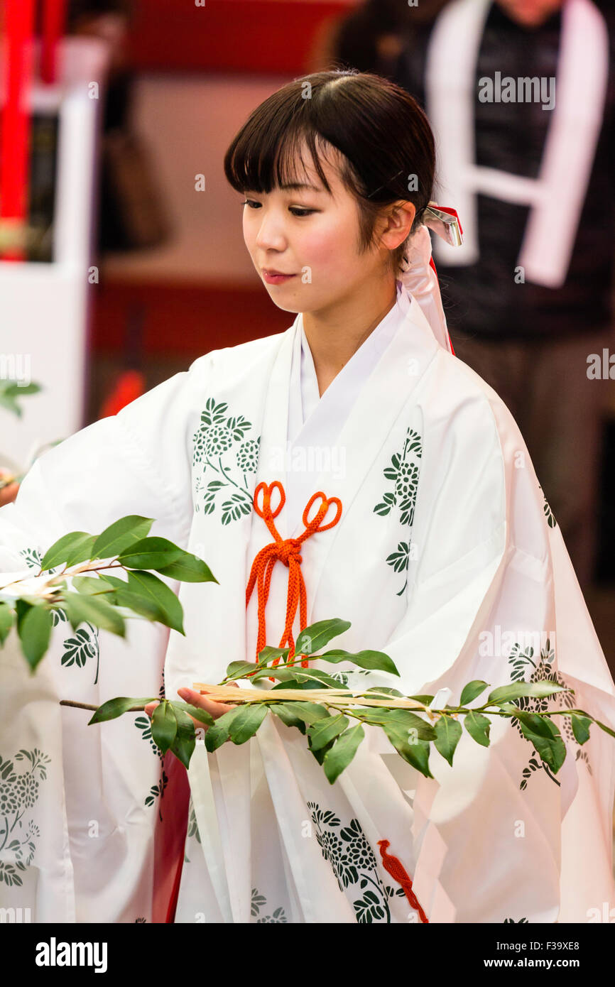 Japan, Kobe, Ikuta Shinto Shrine, Miko, shrine maiden, handing out ...