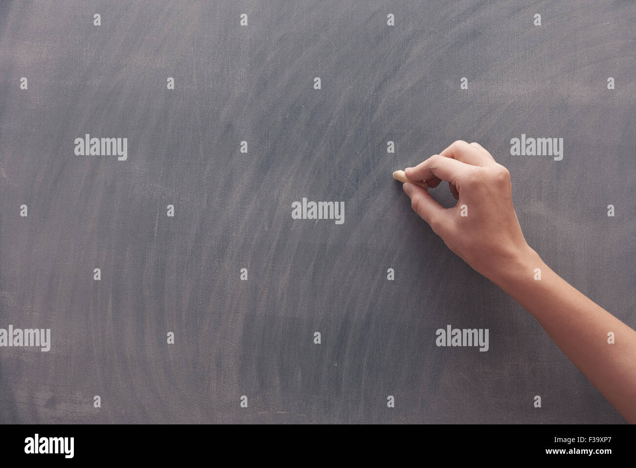 Human hand with chalk at the blackboard Stock Photo - Alamy