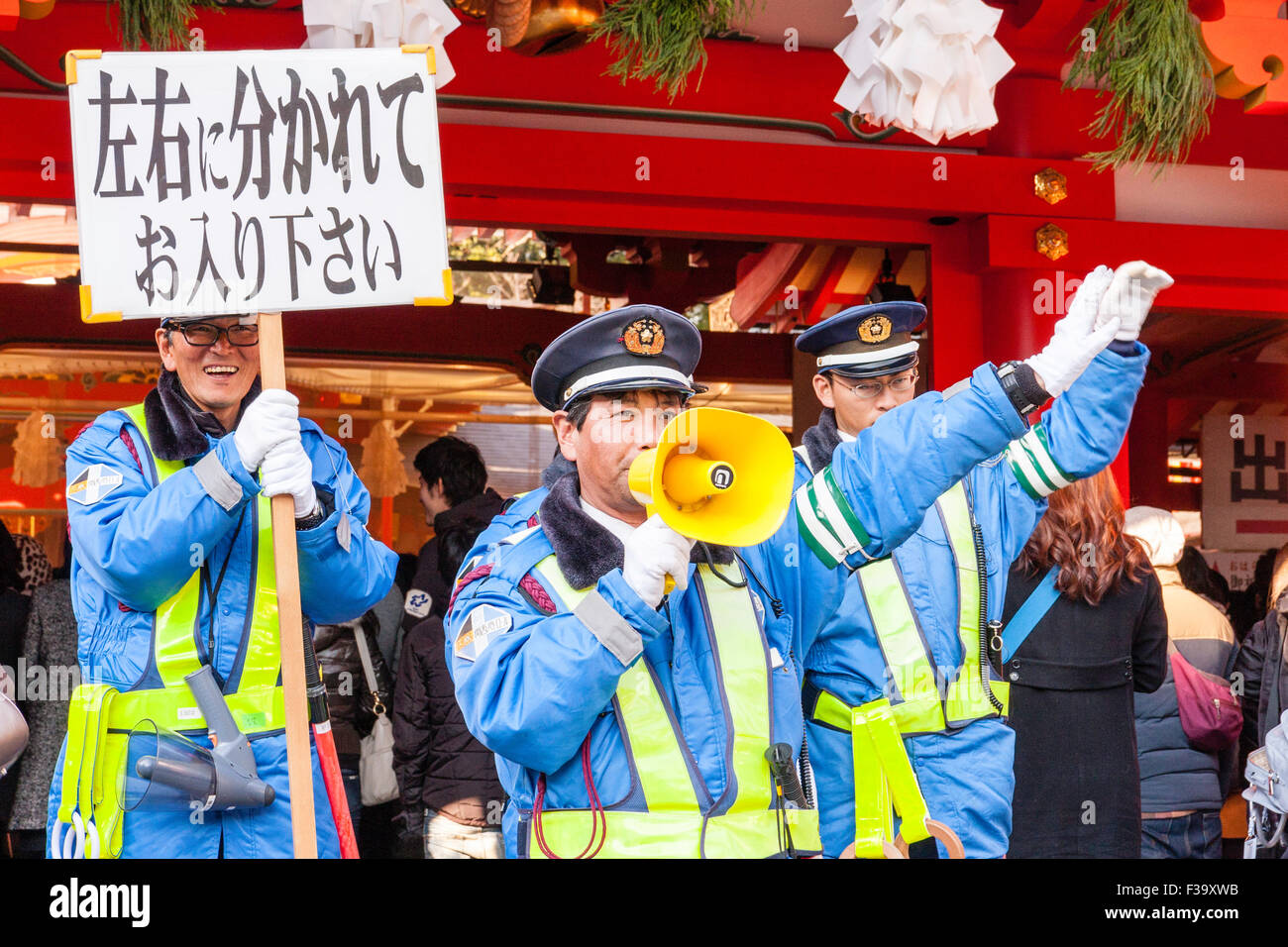 Japanese security men in blue jackets standing in Shinto shrine trying ...