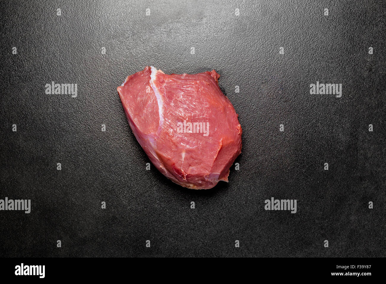 Overhead view eyes round beef meat on black Stock Photo - Alamy