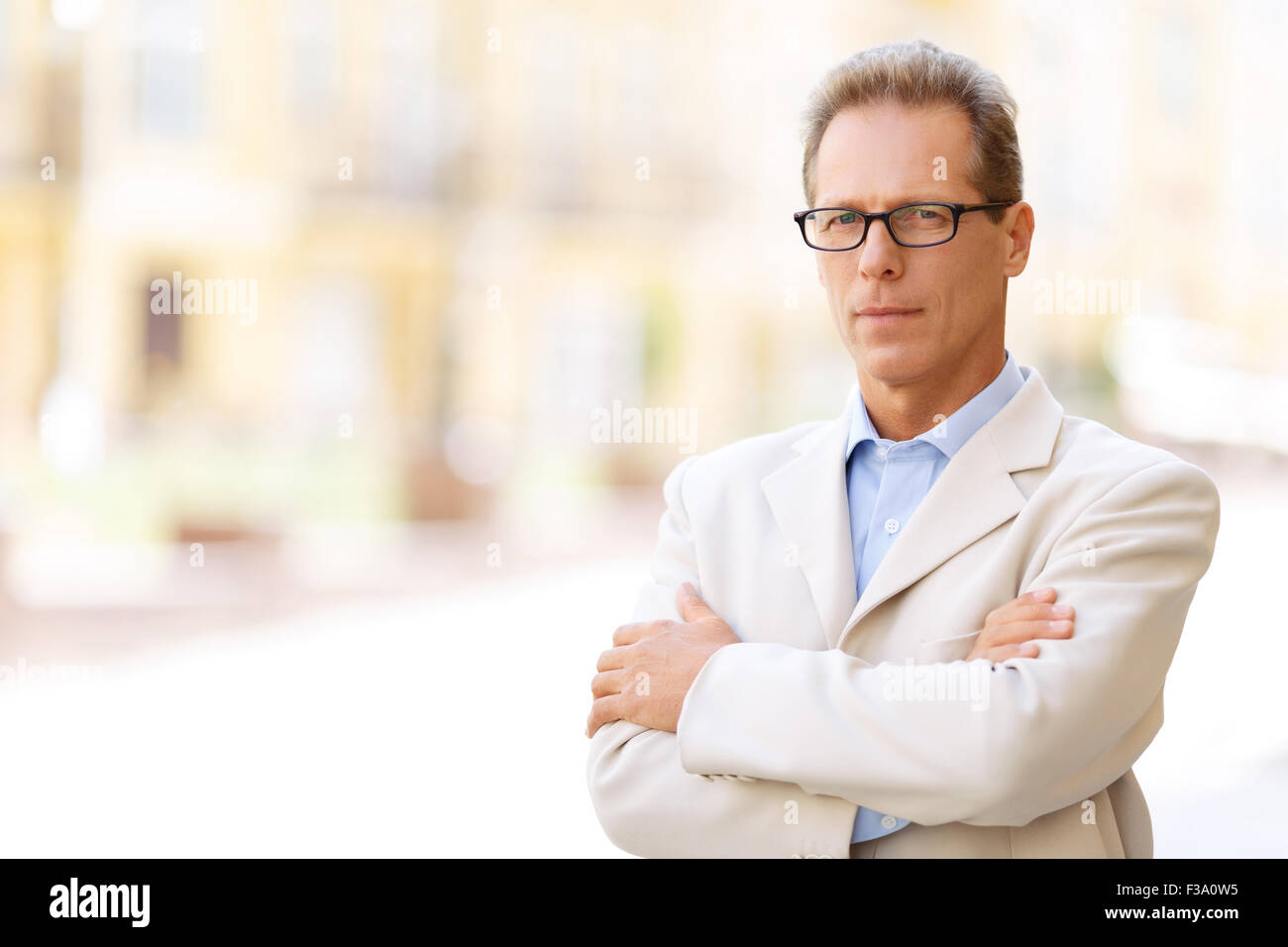 Confidence in mind. Serious confident handsome man folding his hands ...