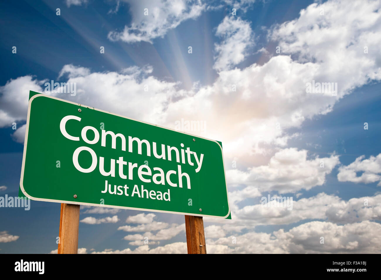 Community Outreach Green Road Sign With Dramatic Clouds and Sky Stock ...