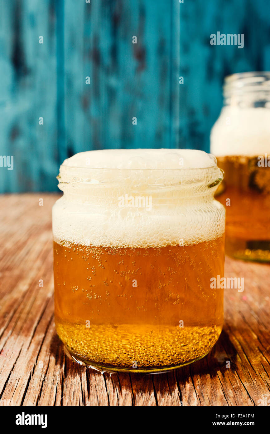 refreshing beer served in glass jars on a rustic wooden surface Stock ...
