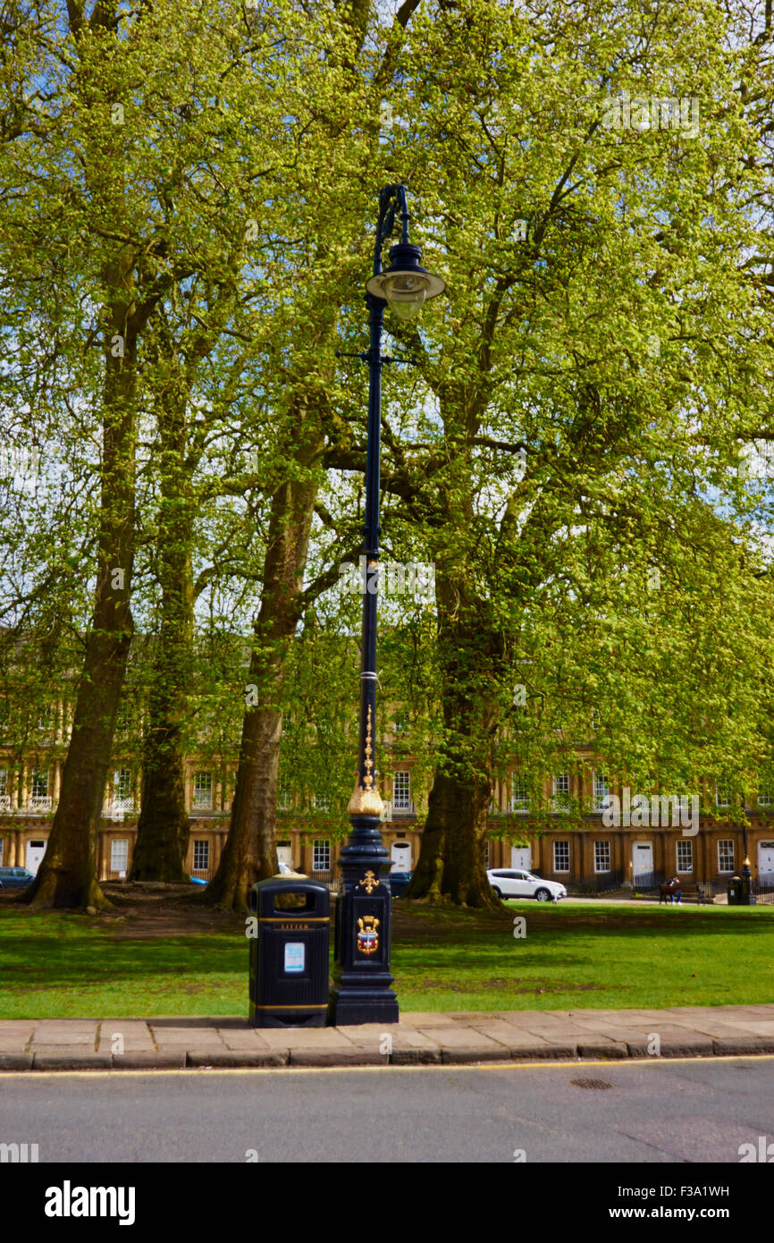 View of The Circus with green grass and trees at centre. Lamp post and ...