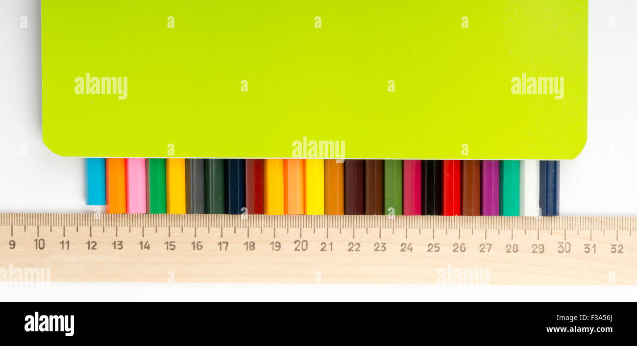 Set of crayons with ruler and copybook Stock Photo - Alamy