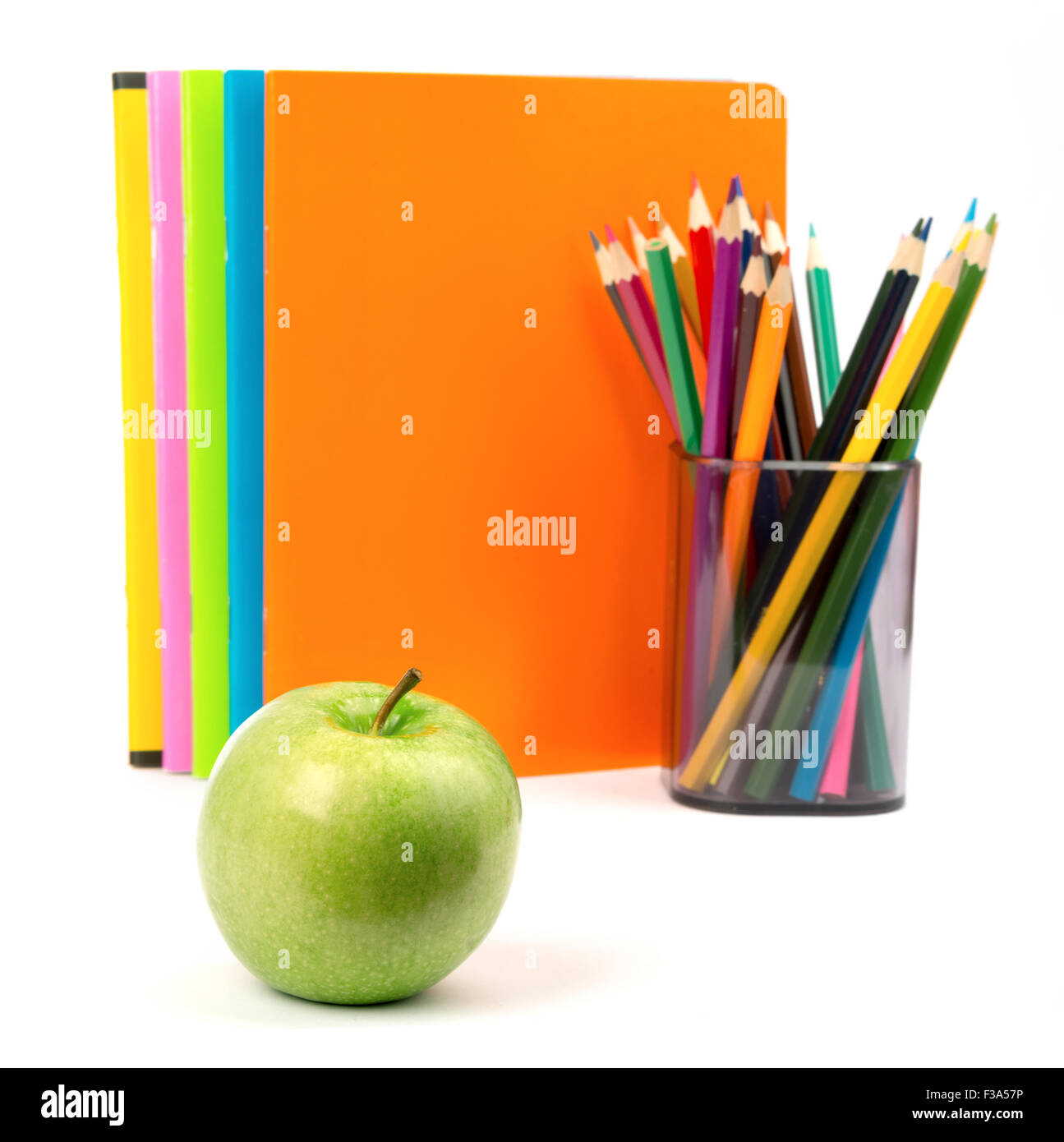 Copybooks with fresh apple and crayons Stock Photo - Alamy