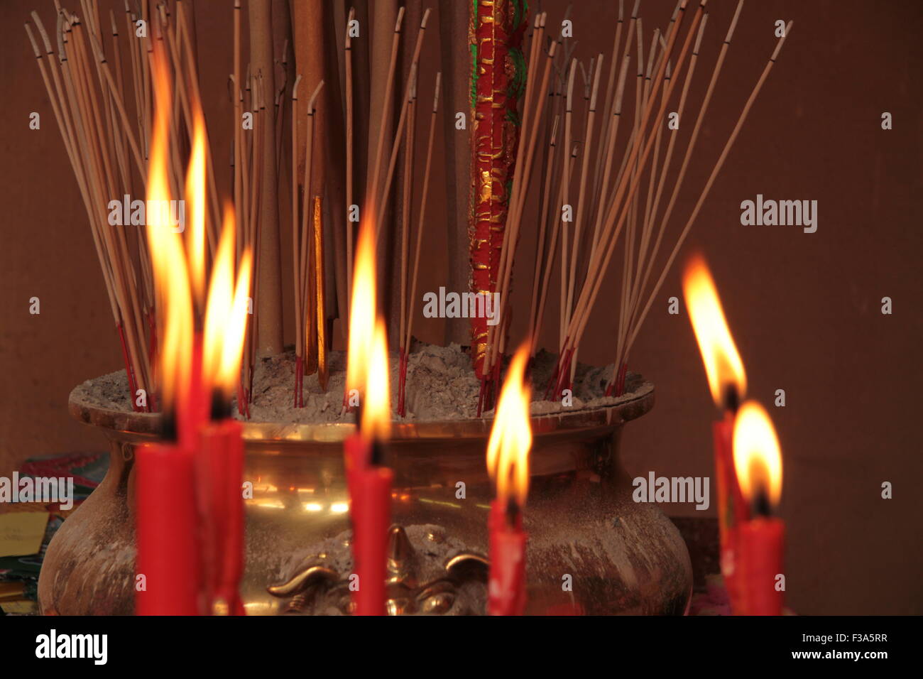 red candles in front of burning incense Stock Photo - Alamy