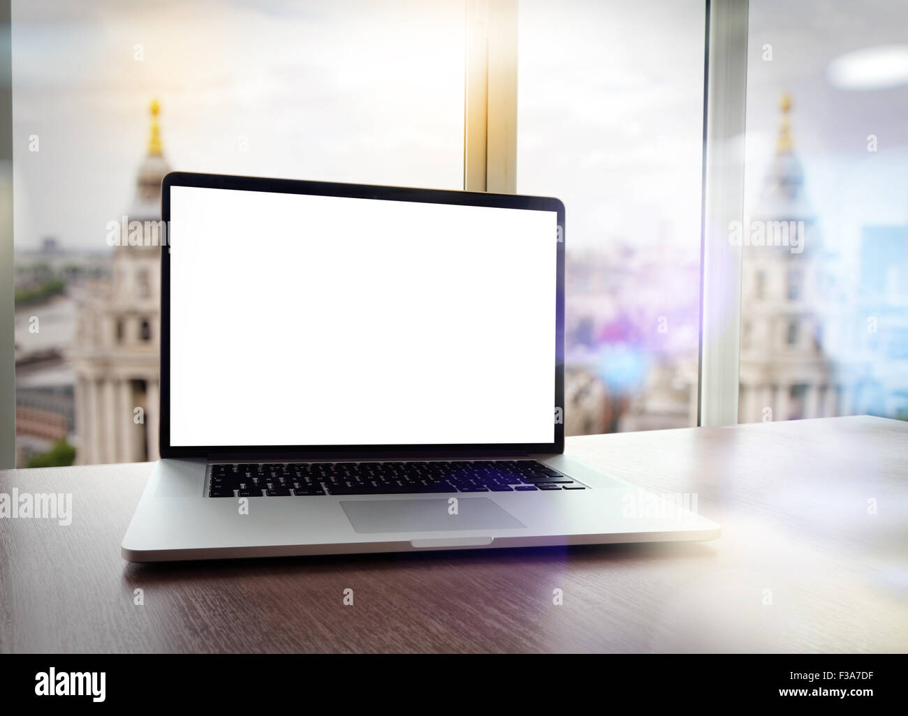 Laptop with blank screen on white desk with blurred background as ...
