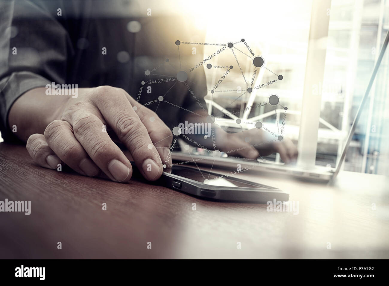 designer hand working and smart phone and laptop on wooden desk in ...