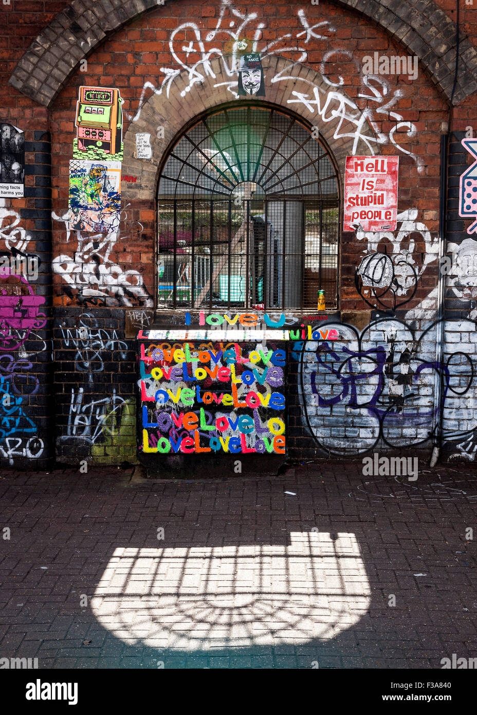 Graffiti and sunlight through a window Stock Photo - Alamy