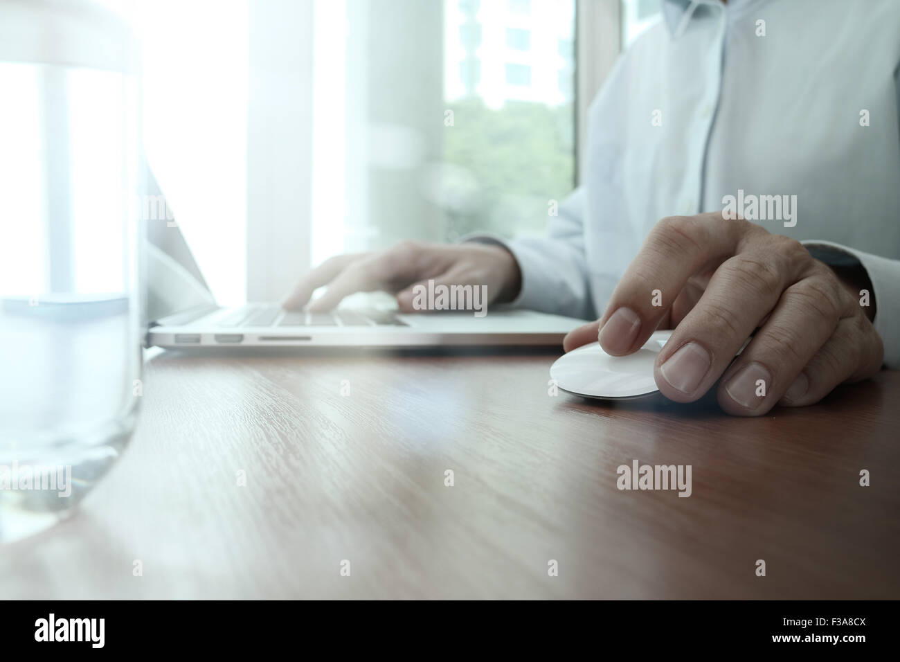 close up of business man hand working on laptop computer with social ...
