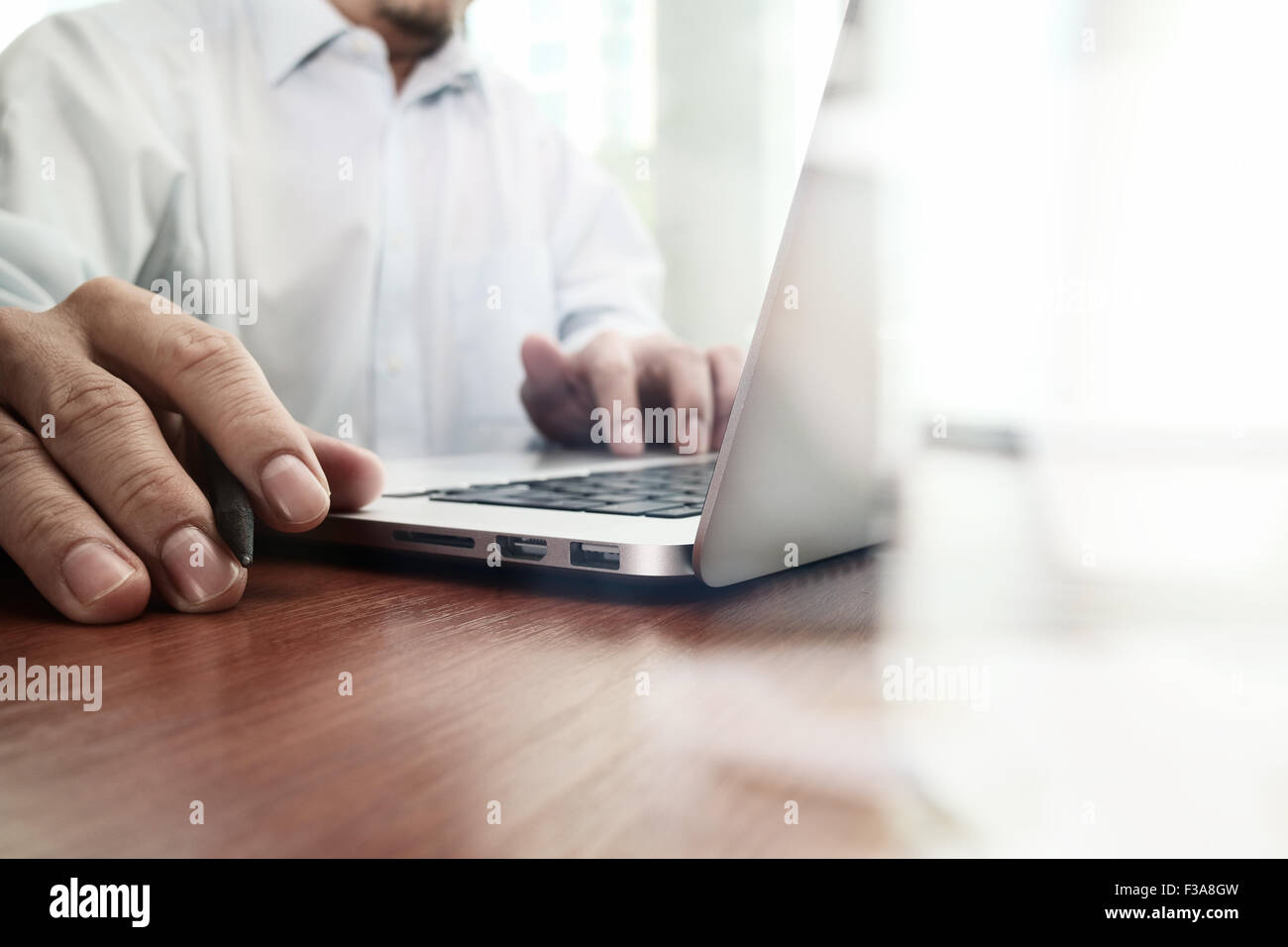 close up of business man hand working on laptop computer with social ...