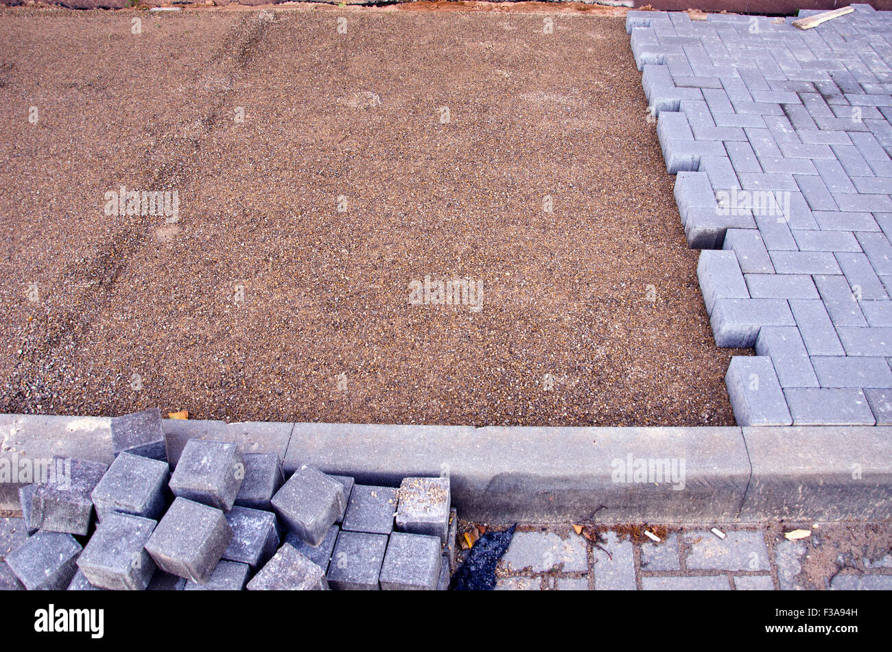 Ongoing work of paving - work place in street Stock Photo - Alamy