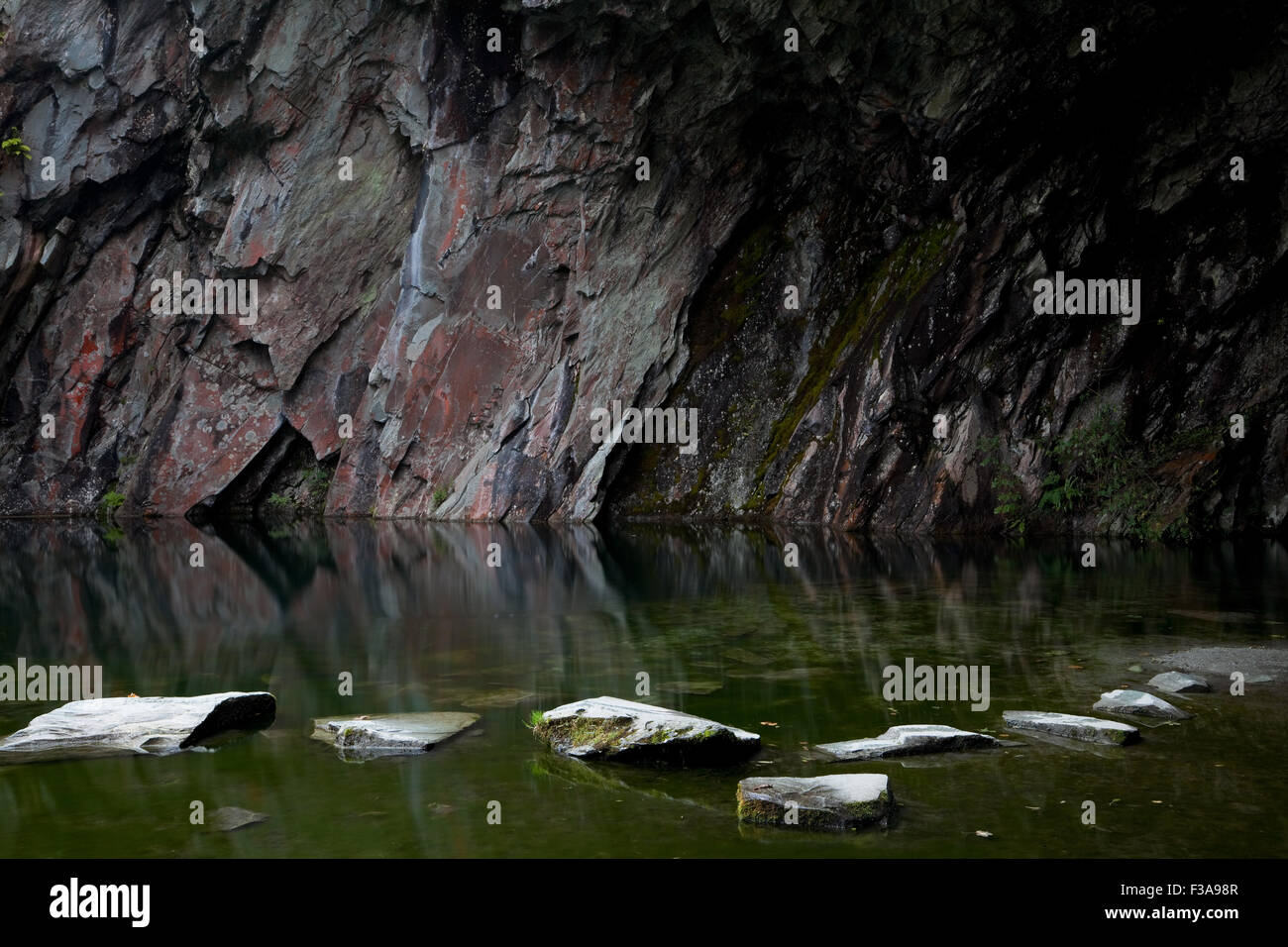 Stepping stones through a pool in Rydal Cave near Grasmere, Cumbria, UK ...